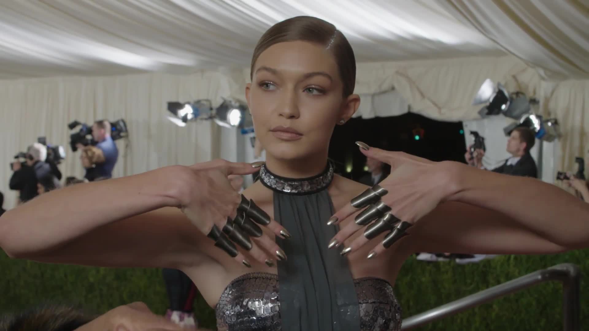 Watch Gigi Hadid on Her Futuristic Bathing Suit and Chrome Knuckles at ...